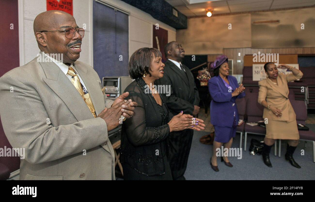 Pastor Garnet Mimms, left, sings with congregants during services at ...