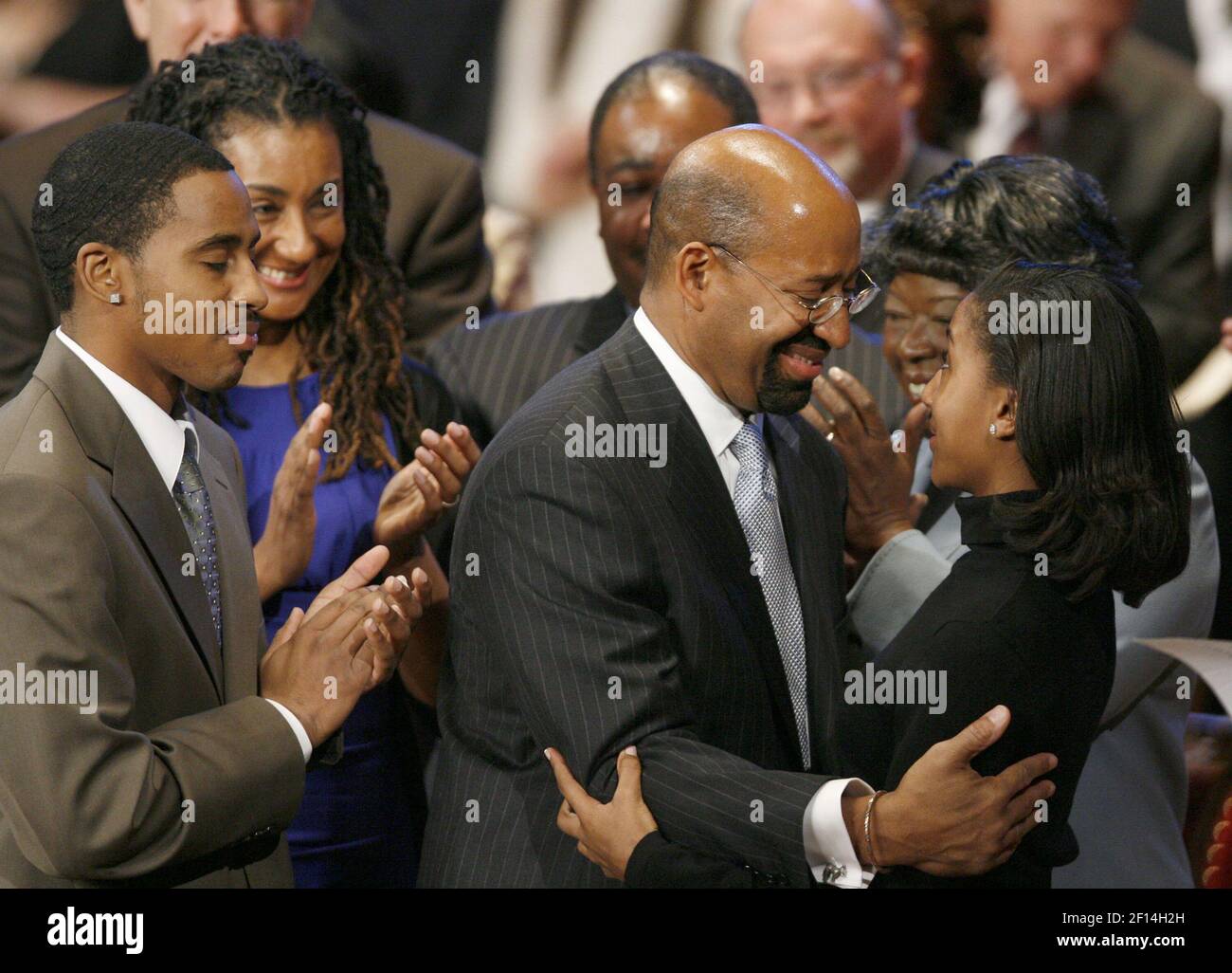 Philadelphia Mayor Michael Nutter, center, hugs his daughter, Olivia ...
