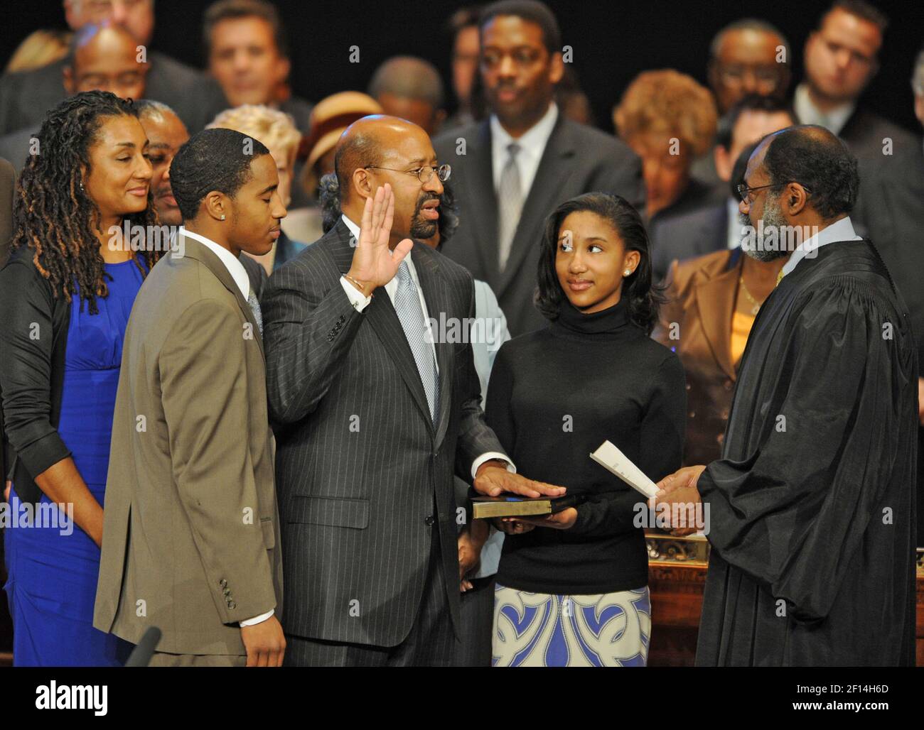 Michael Nutter, with his hand on a bible held by his daughter Olivia ...