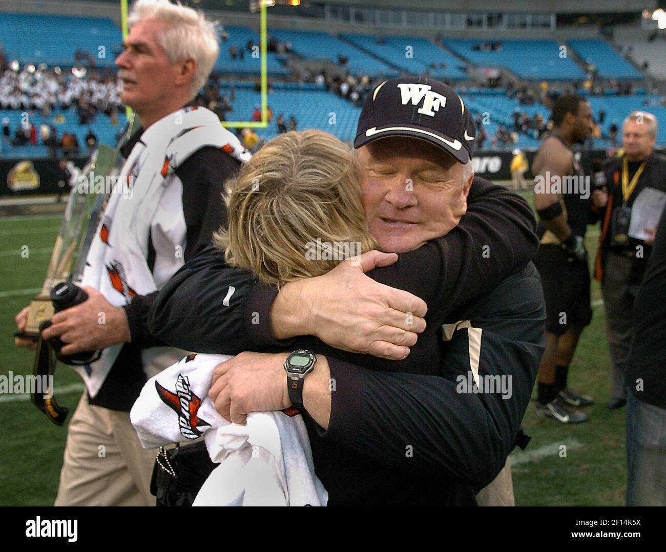 Wake Forest head coach Jim Grobe hugs his wife Holly as he celebrates ...