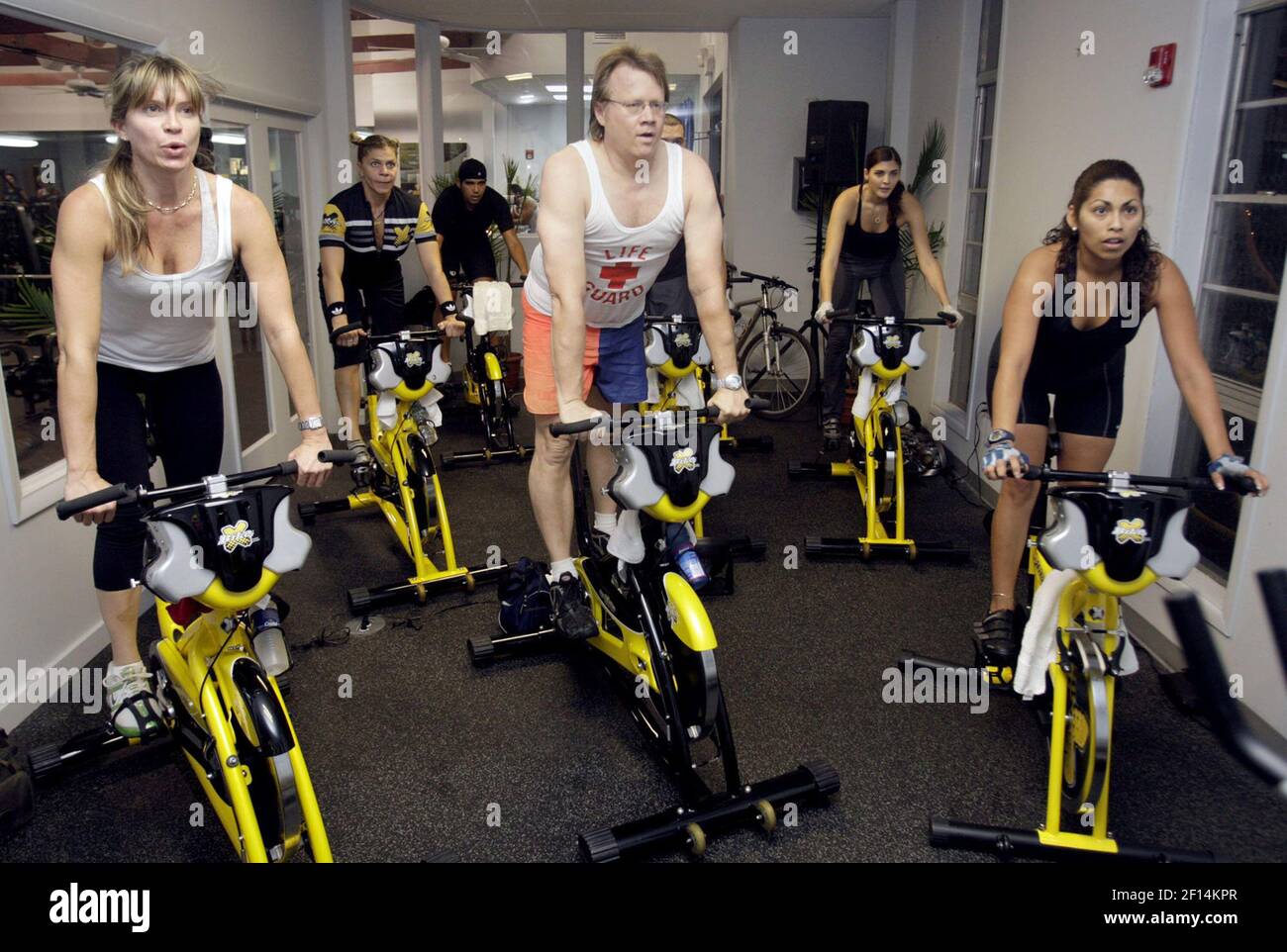 Miami Herald writer Howard Cohen, center, tries out an X-Biking class ...