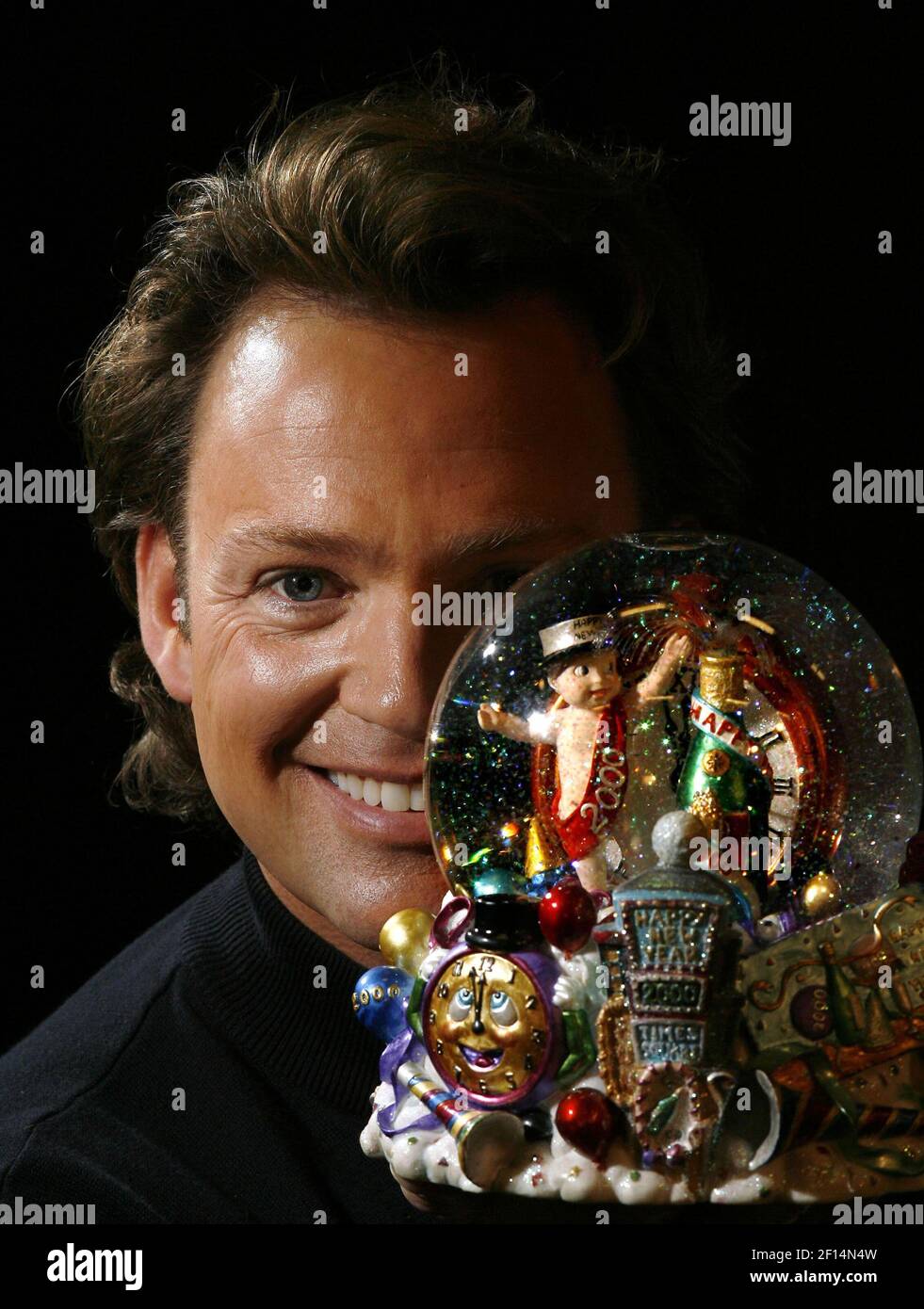 Lifestyle expert Randy Altig shows off a snow globe that he has saved ...