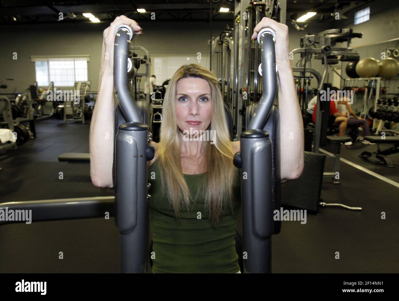 Trainer Nancy Cole demonstrates an exercise on the butterfly pectoral ...