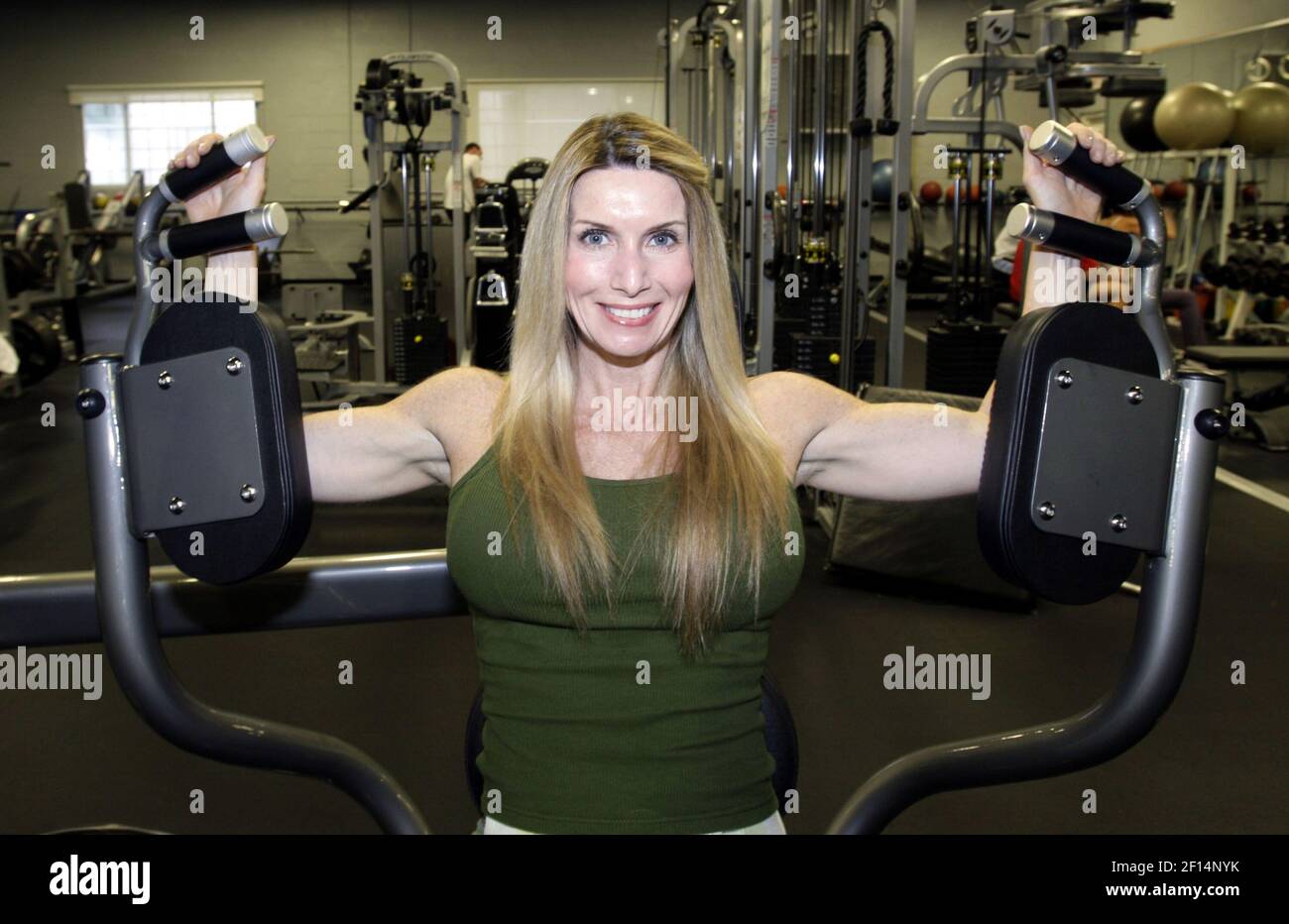 Trainer Nancy Cole demonstrates an exercise on the butterfly pectoral ...