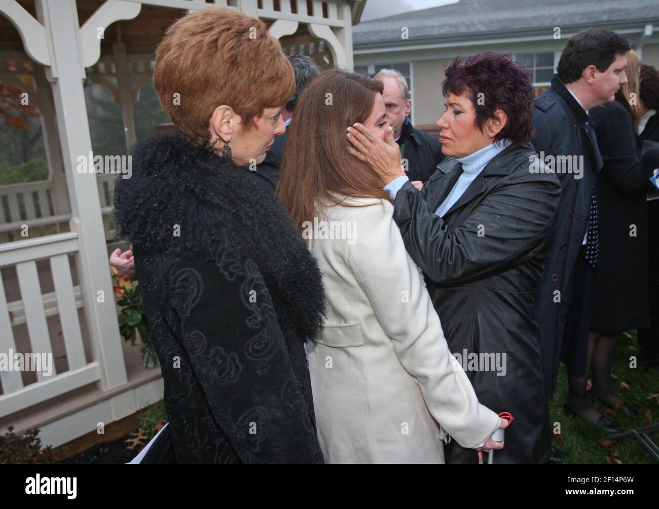 Luann Dubin, a friend of Ellen Gregory Robb (right), grabs the face of ...