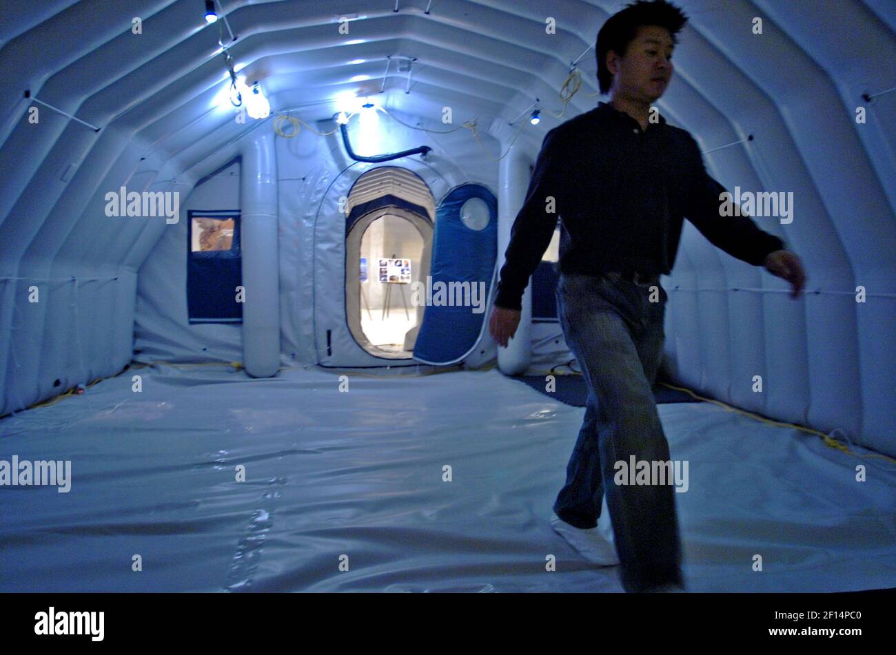 Todd Hong, a NASA instrumentation engineer, walks through the inside of ...