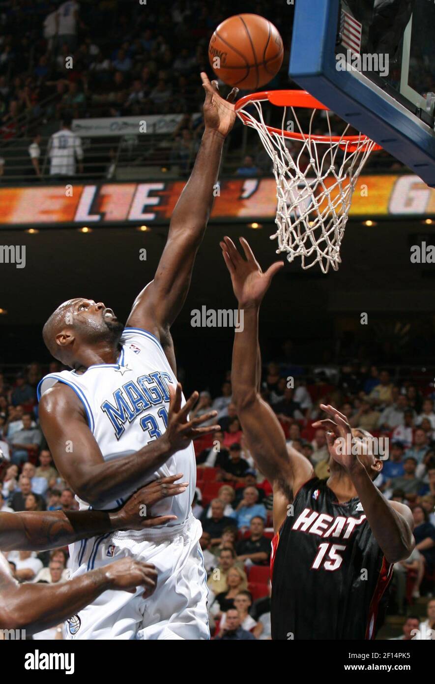 Orlando Magic center Adonal Foyle, left, scores over Miami Heat center ...