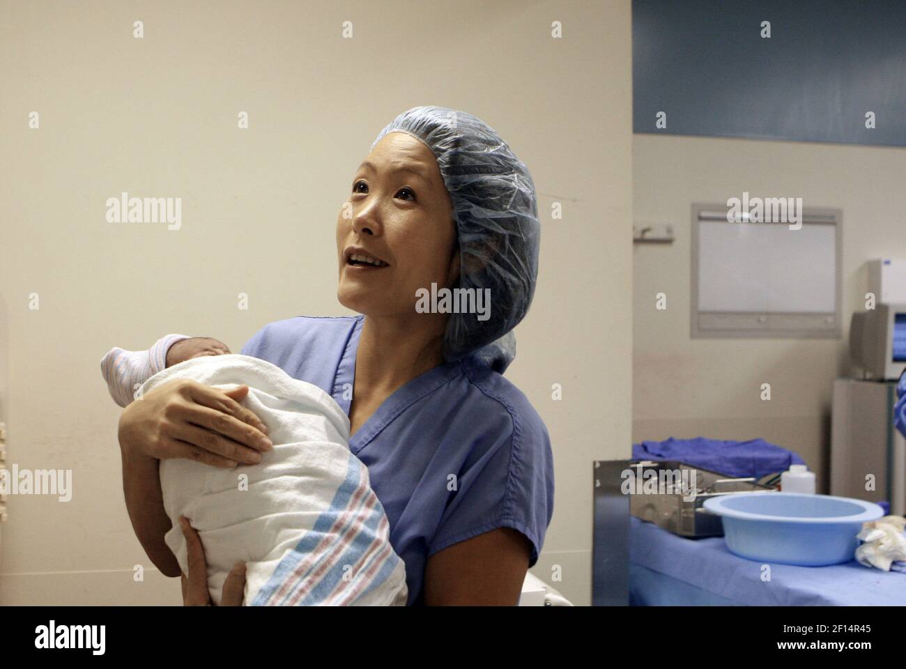 Laborist Dr. Hyun-Joo Lee holds the baby she birthed just minutes after ...