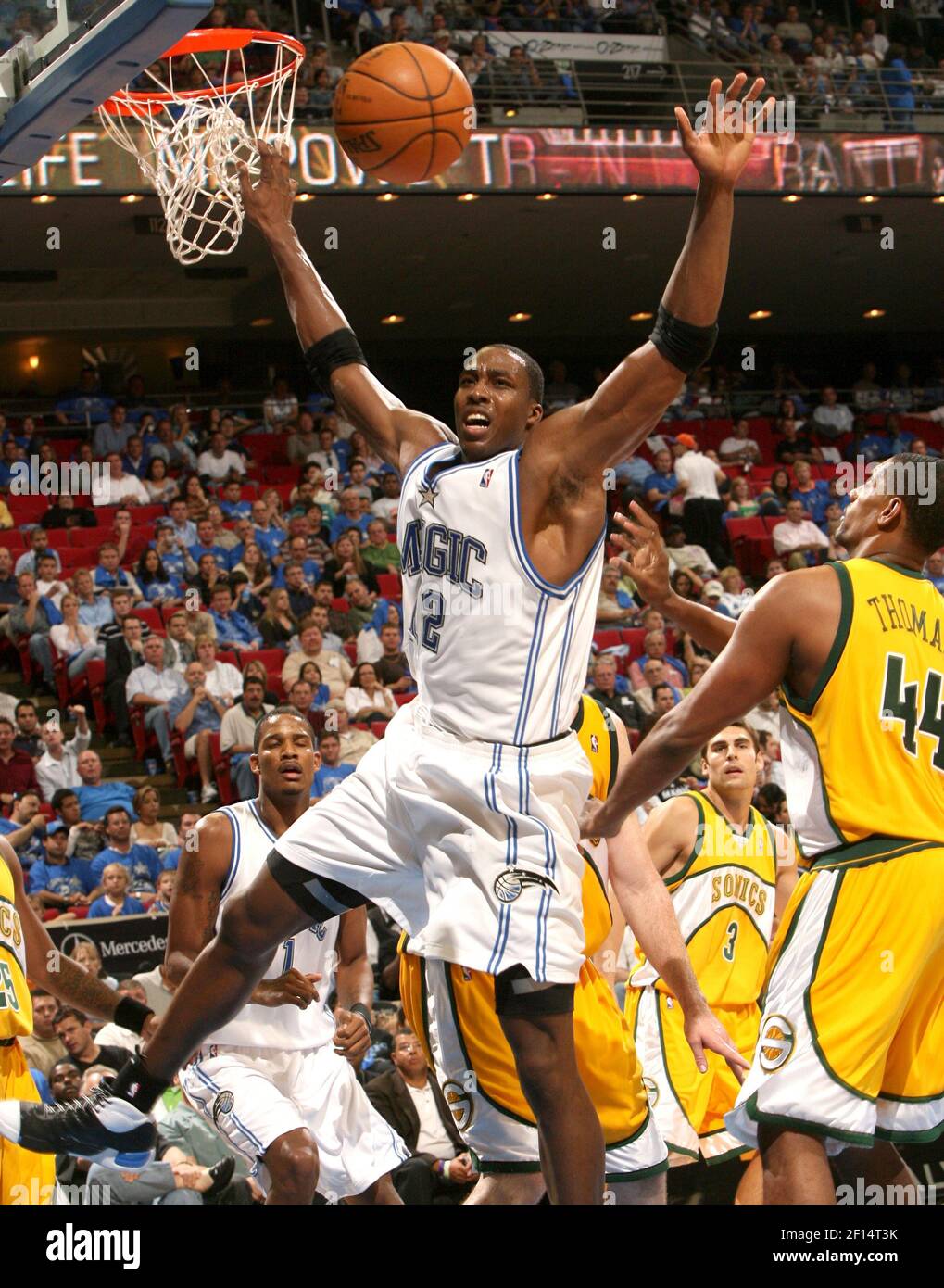 Orlando Magic center Dwight Howard (center) has the ball smack away ...