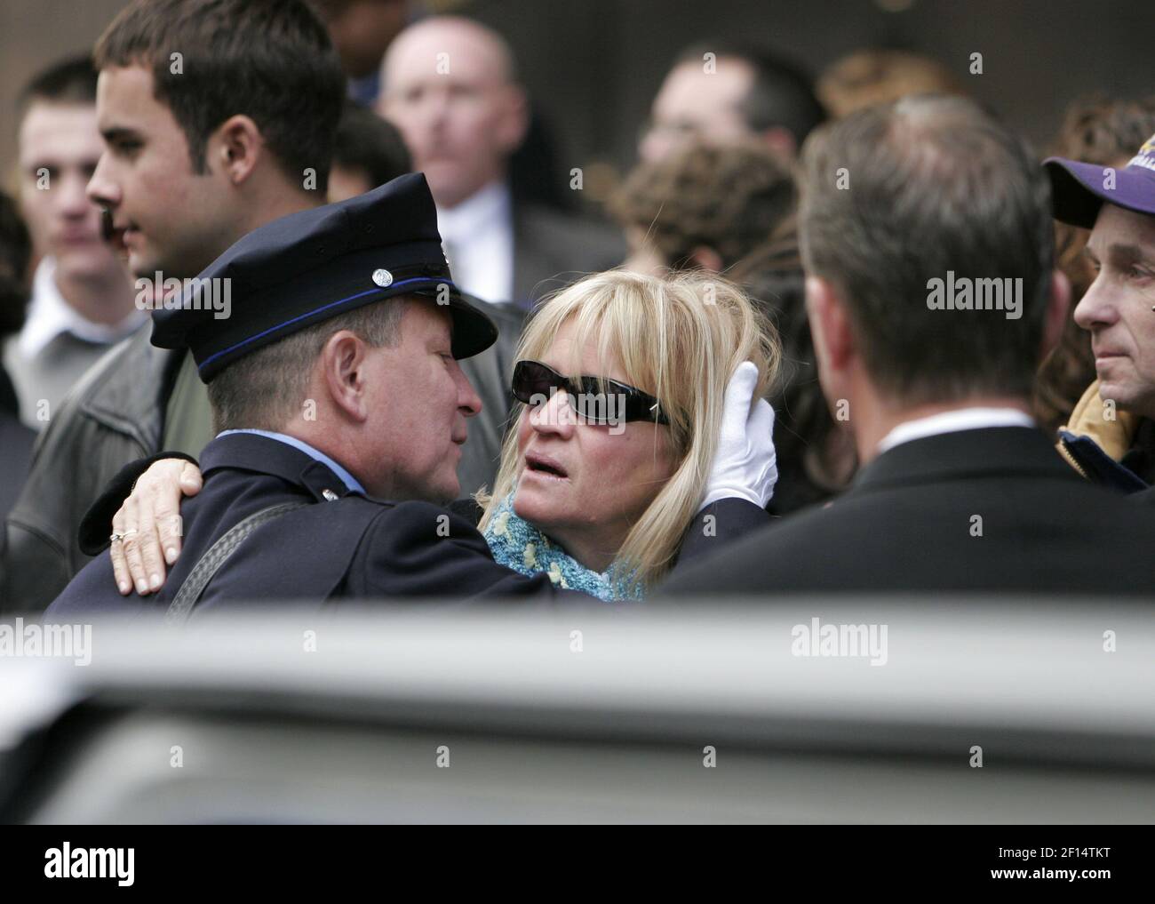 Judith Cassidy, center, wife of slain police officer Chuck Cassidy, is ...