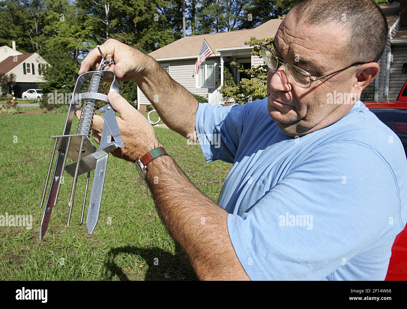 Roger Copenhaver of York County, Virginia, holds a mole trap that ...