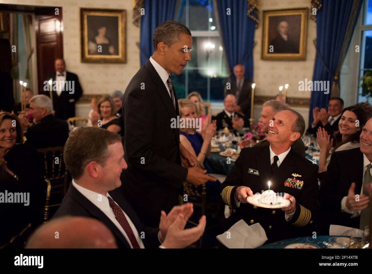 President Barack Obama presents a birthday cake to Admiral Jonathan ...