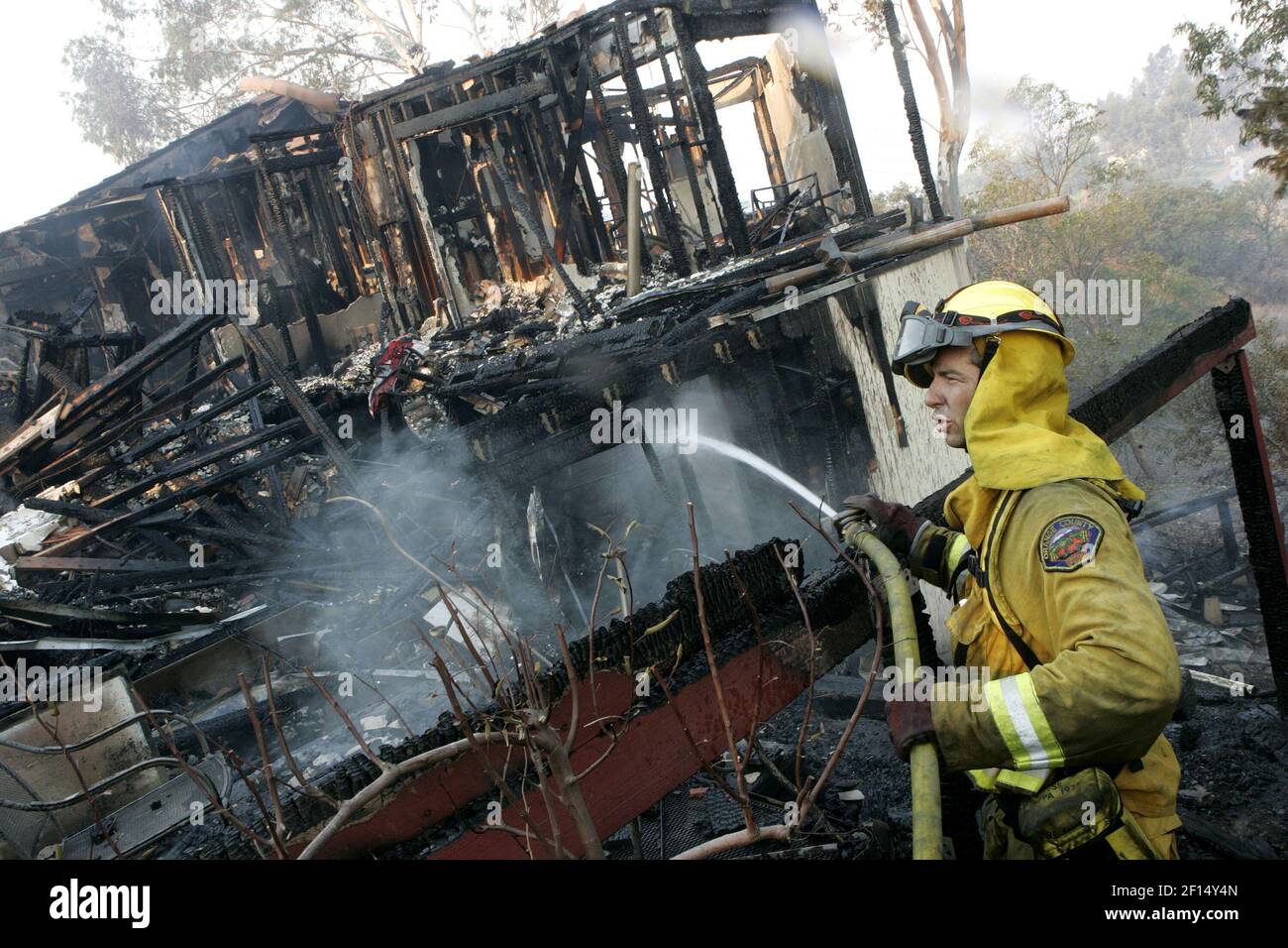 Orange County Fire Authority firefighter Cliff Blasi cools hotspots in ...