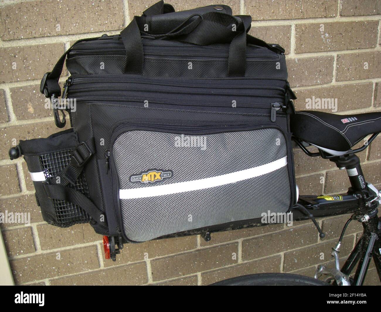 The Topeak MTX Trunk Bag DXP slides on and off a rear bicycle rack with ...