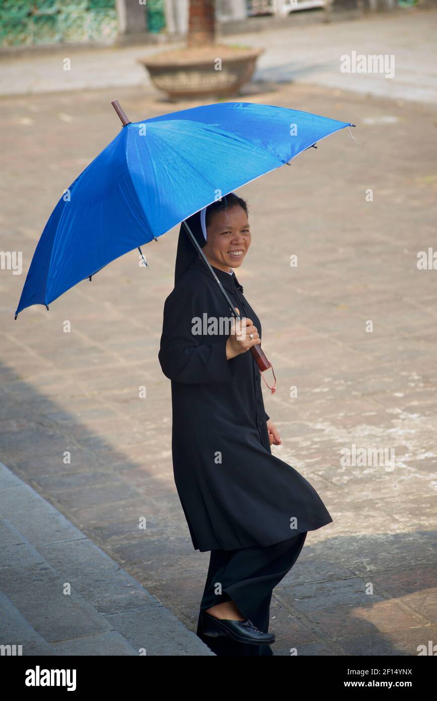 Vietnamese Catholic nun using a parasol at Phat Diem Cathedral, Phat ...