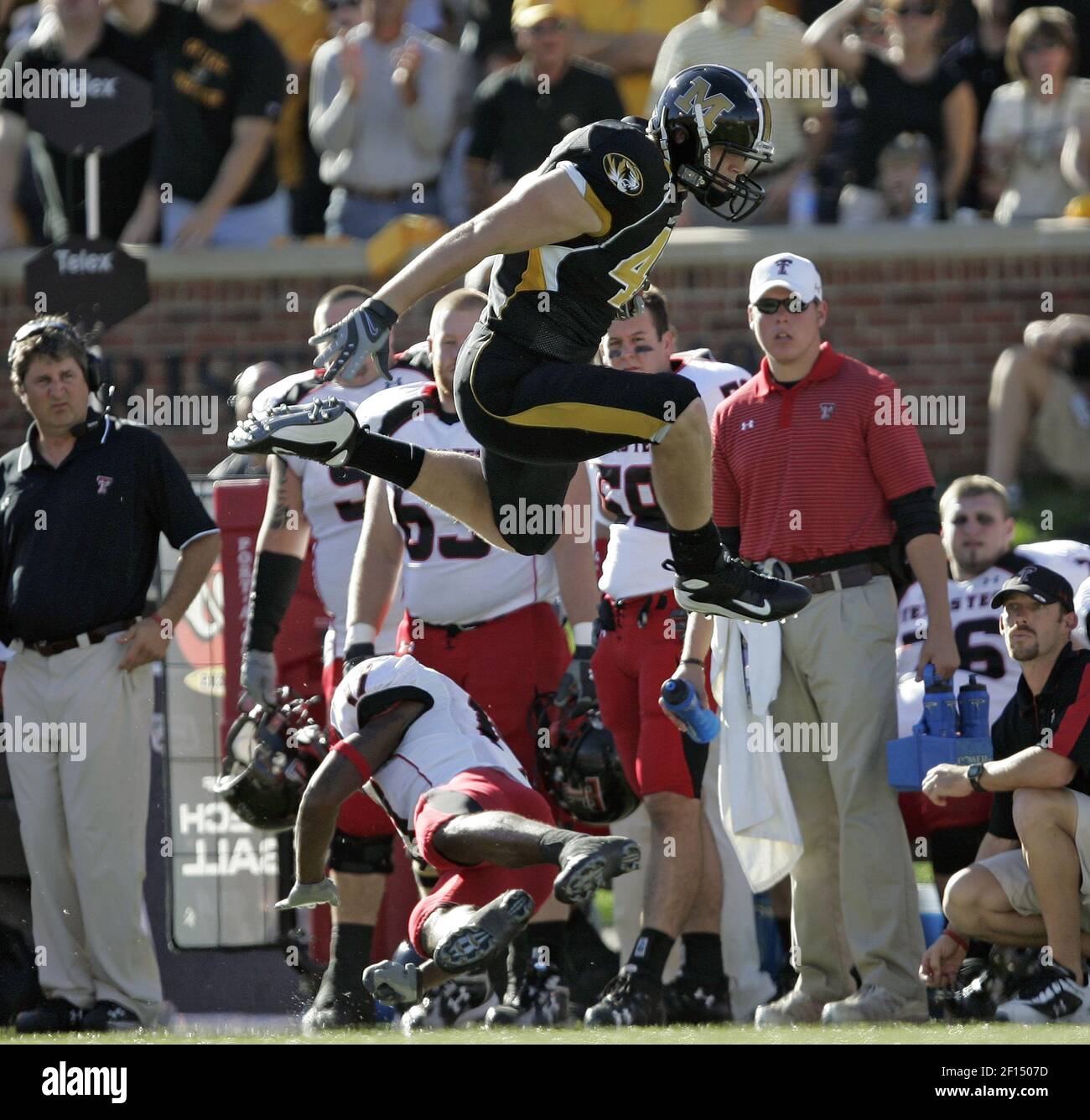 Missouri's Chase Coffman leaps over Texas Tech's Chris Parker (bottom ...
