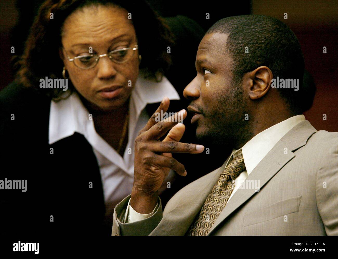 Defense attorney Penelope Marshall huddles with her client Brian ...
