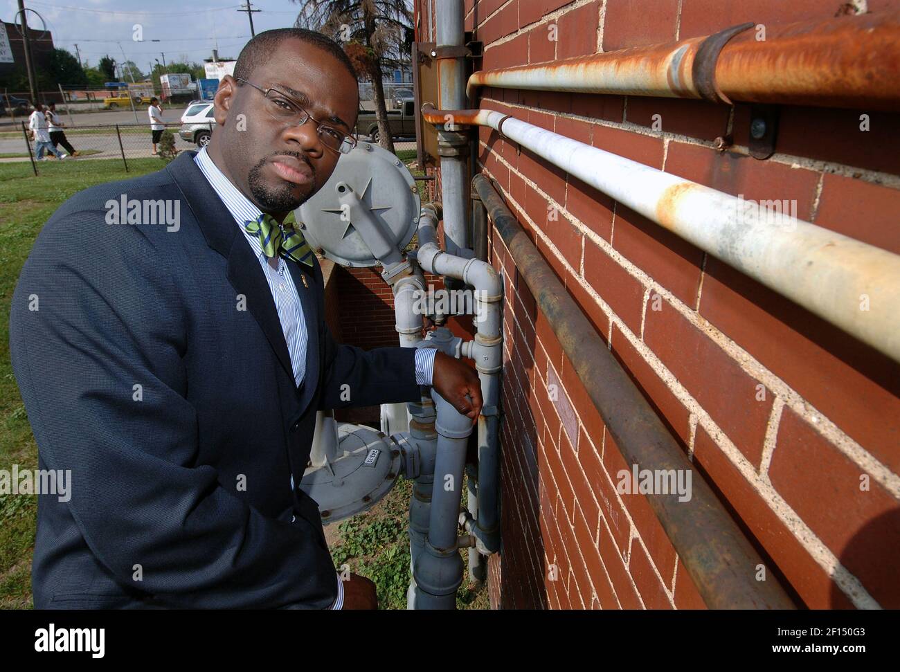 Reverent Andre Spivey poses next to conduit that contains copper wiring ...
