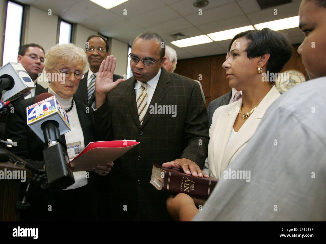 William Marsh, council president, center, is sworn in by city clerk ...