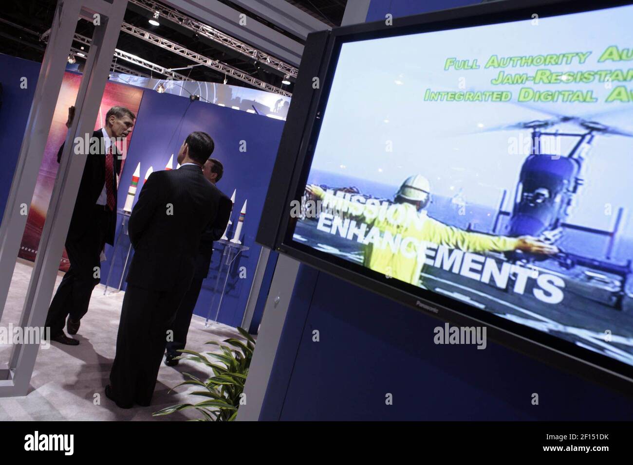 Greg Stolt (left) of the Lockheed Martin Corporation speaks with ...