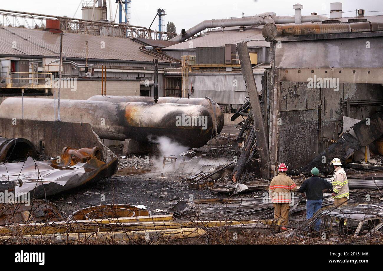 Firefighters survey the damage on Sunday, October 7, 2007, at the ...