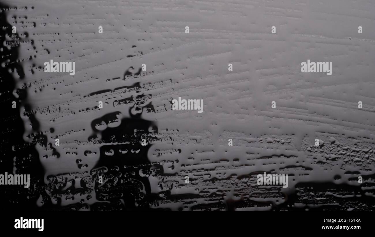 Water drops on metal surface. water on the black glass. rain on the ...
