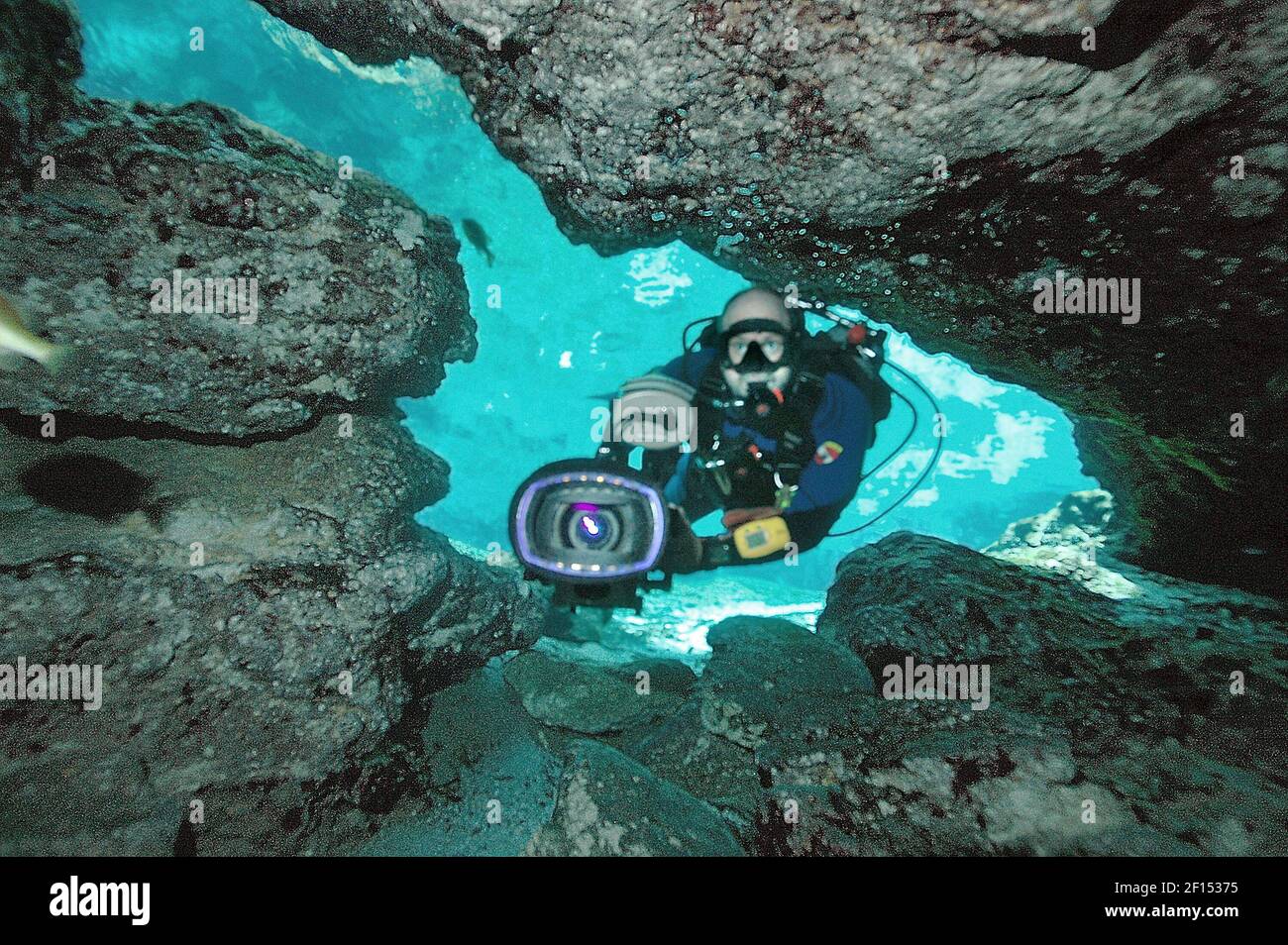 Wes Skiles, cave diver and underwater photographer, enters an ...