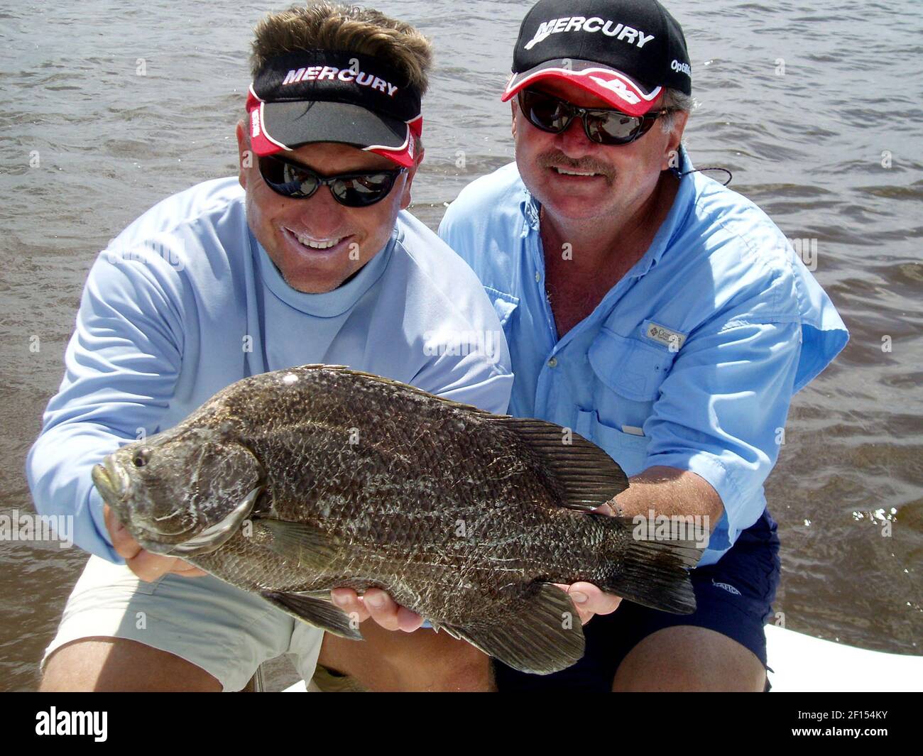 Captain Brian Sanders (left) and captain Herb Kehoe admire a tripletail ...