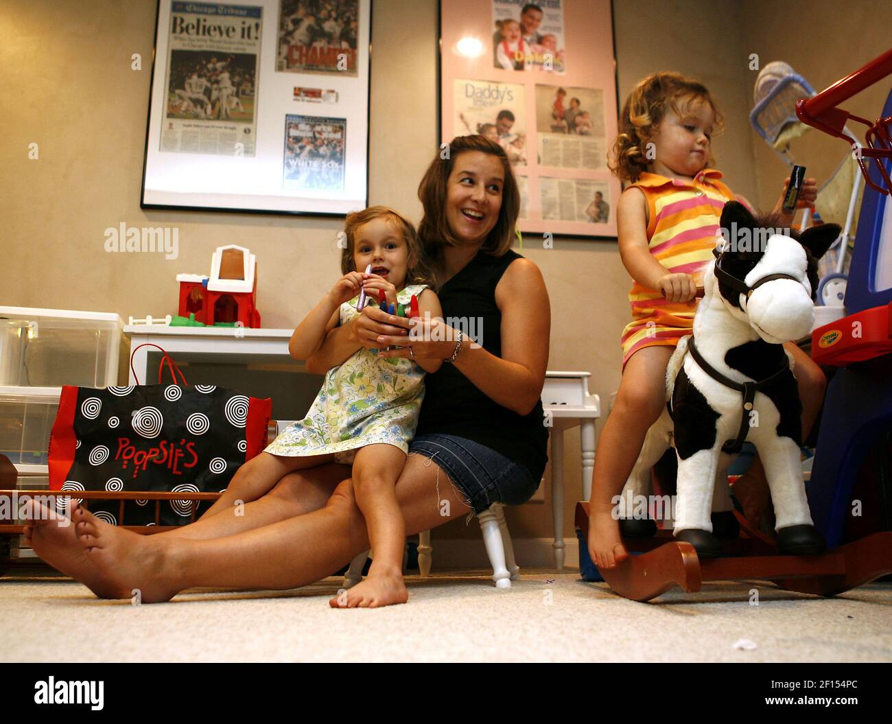 Cathy Adams, center, plays with her two daughters, Jacey, 4, sitting on ...