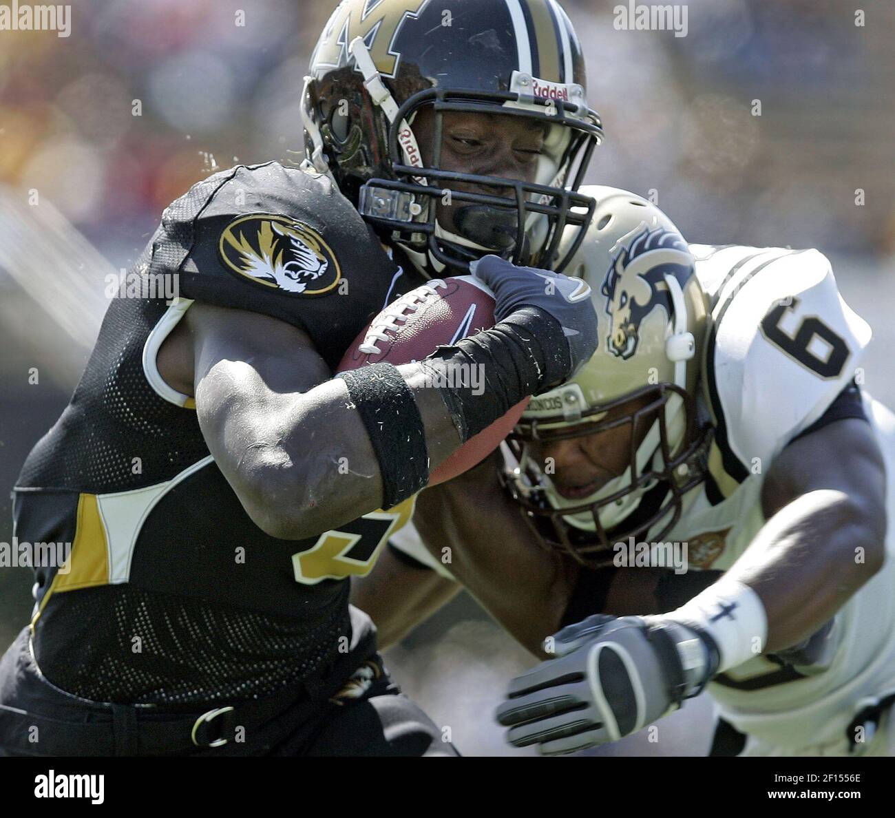 Missouri's Jeremy Maclin, left, runs through Western Michigan's Londen ...
