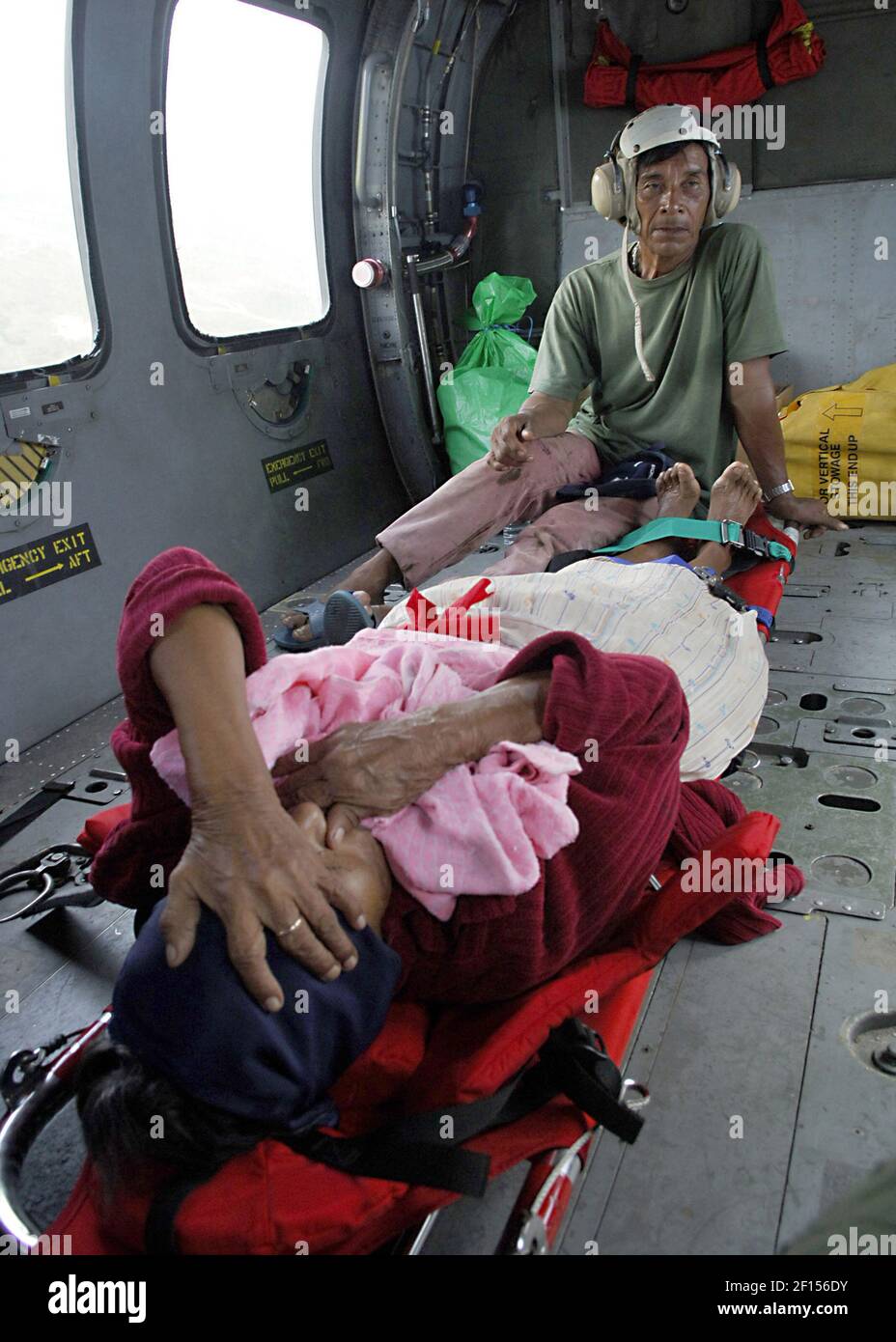 An injured passenger tries to calm herself just before take-off during ...