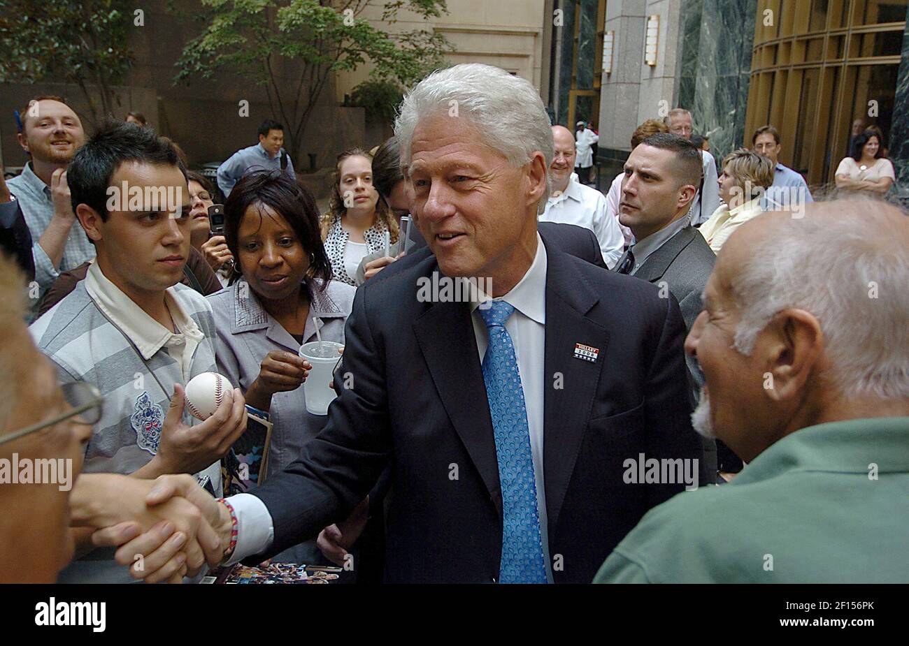 Former president Bill Clinton shakes hands after arriving at the City ...