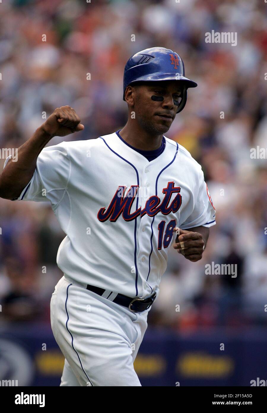 The New York Mets' Moises Alou pumps his fist as he runs up the first ...