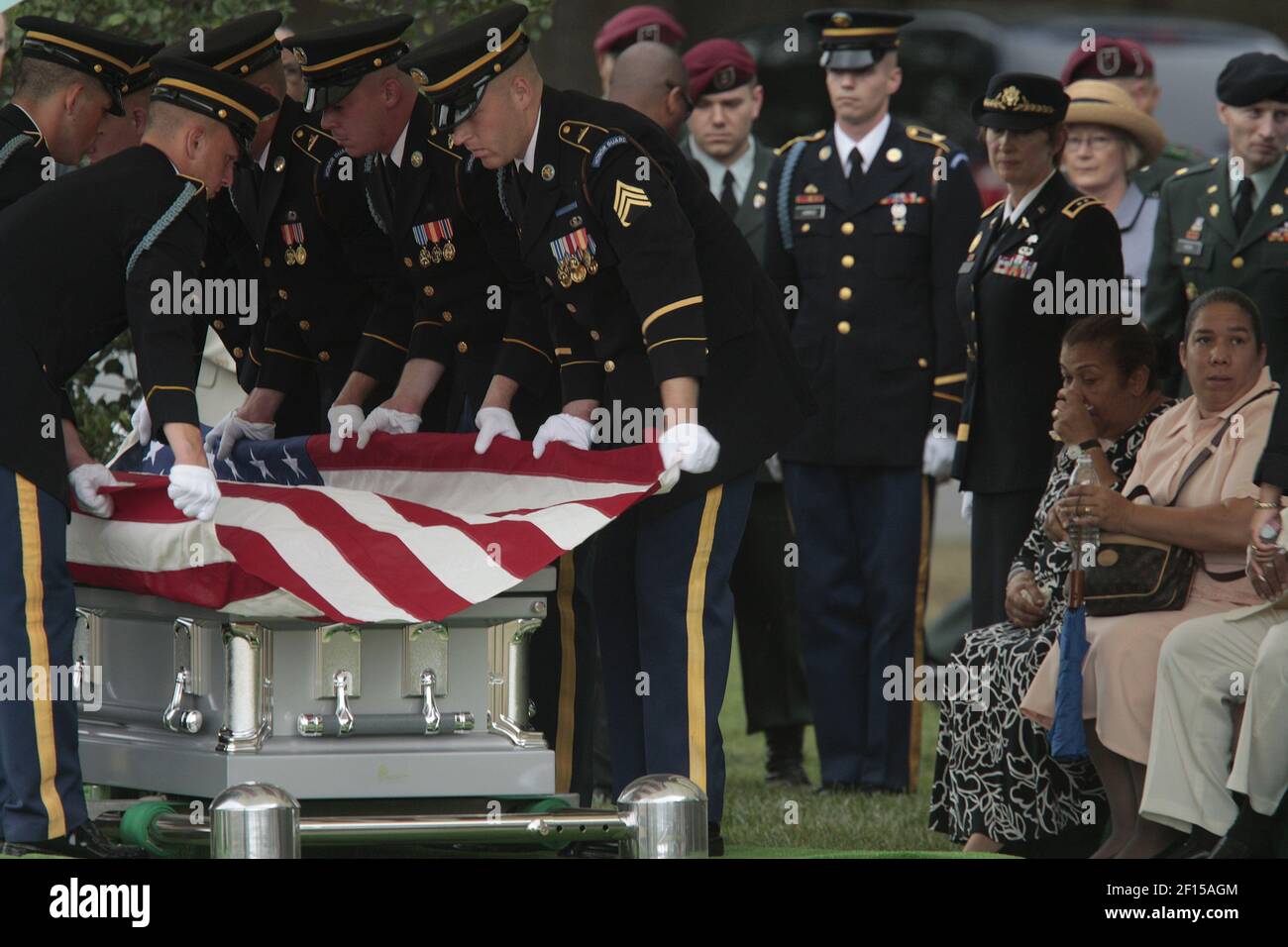 Iris Santiago, the mother of Army Capt. Maria Ines Ortiz, center, and ...