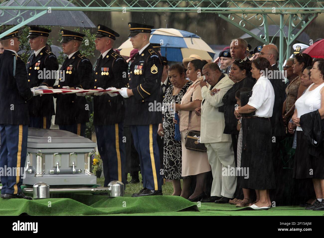 Iris Santiago, the mother of Army Capt. Maria Ines Ortiz, center, and ...