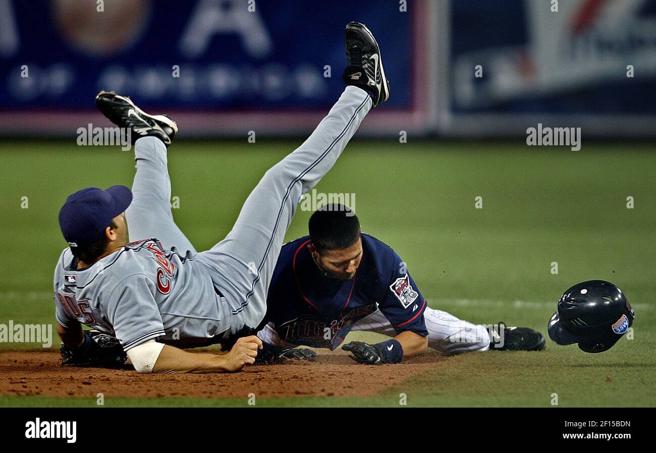 Cleveland Indians second baseman Mike Rouse, left, flips over Minnesota ...