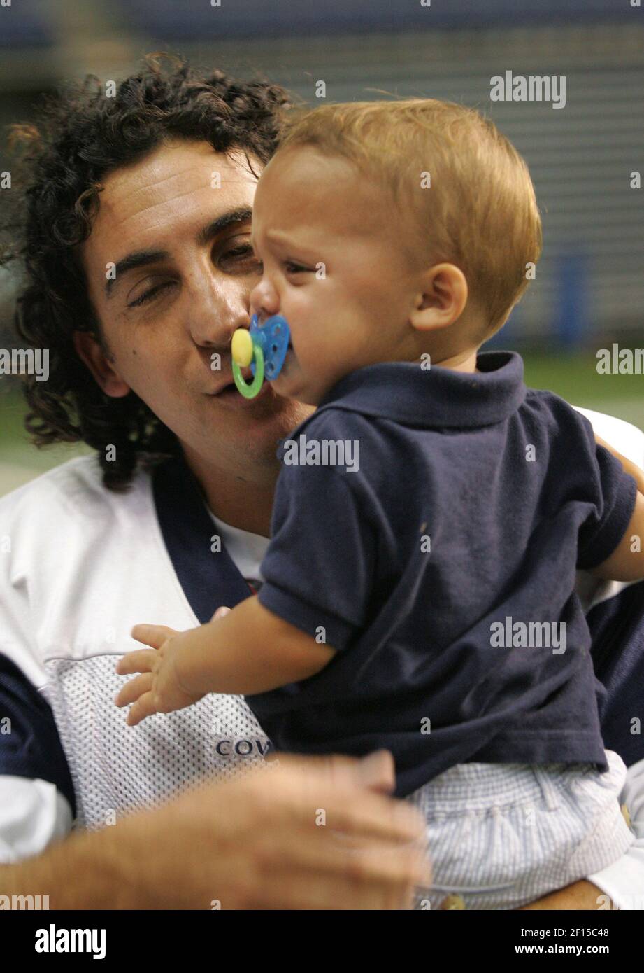 Dallas Cowboys Martin Gramatica tries to calm his 16-month-old son Rico ...