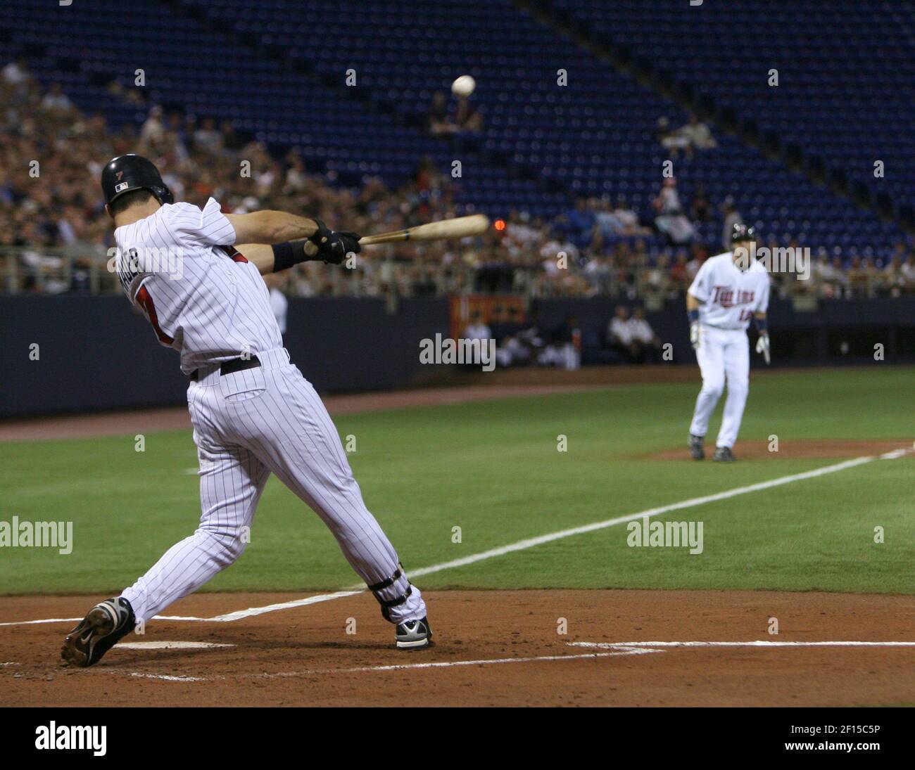 Minnesota Twins Joe Mauer hits a two-RBI double that scores Jason Tyner ...