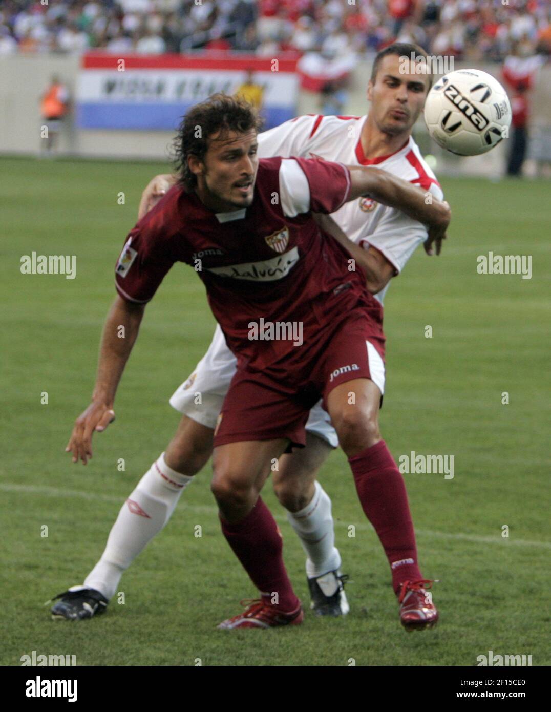 Wisla's Piotr Brozek (rear) and Sevilla's Antonio Jose Puerta battle in ...