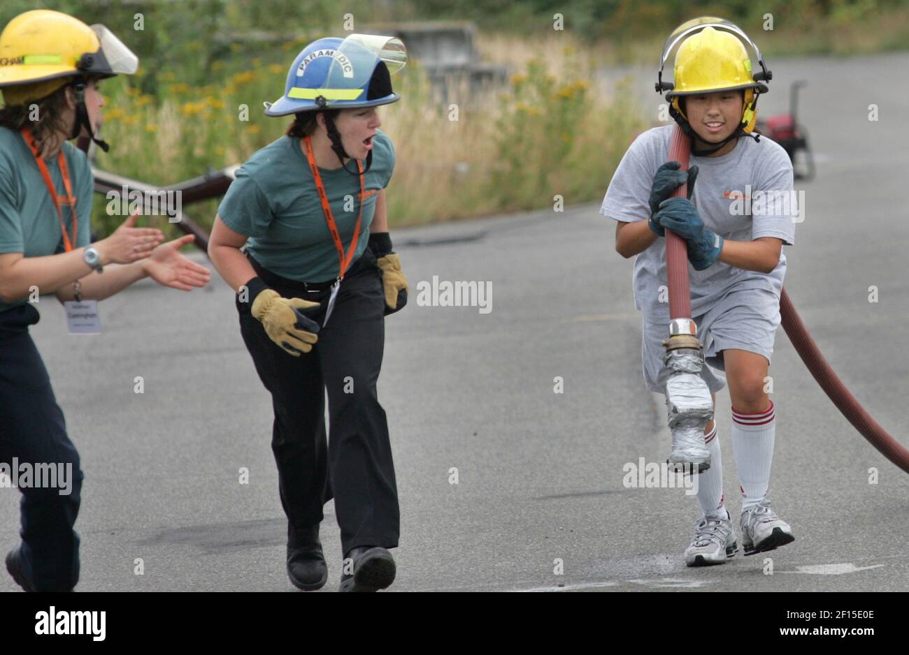Camp Blaze camper Melody Liao, right, of Austin, Texas, pulls a hose ...
