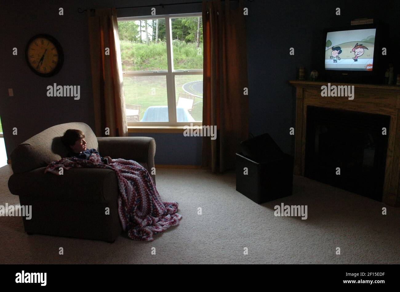 As part of his routine, Cody Mogensen, 10, who is autistic, watches ...