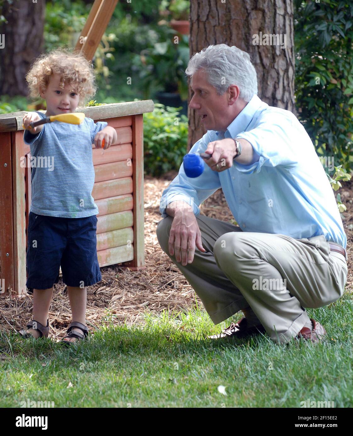 Two-year-old Conor, left, and his father Dave Dougherty, 46, play golf ...