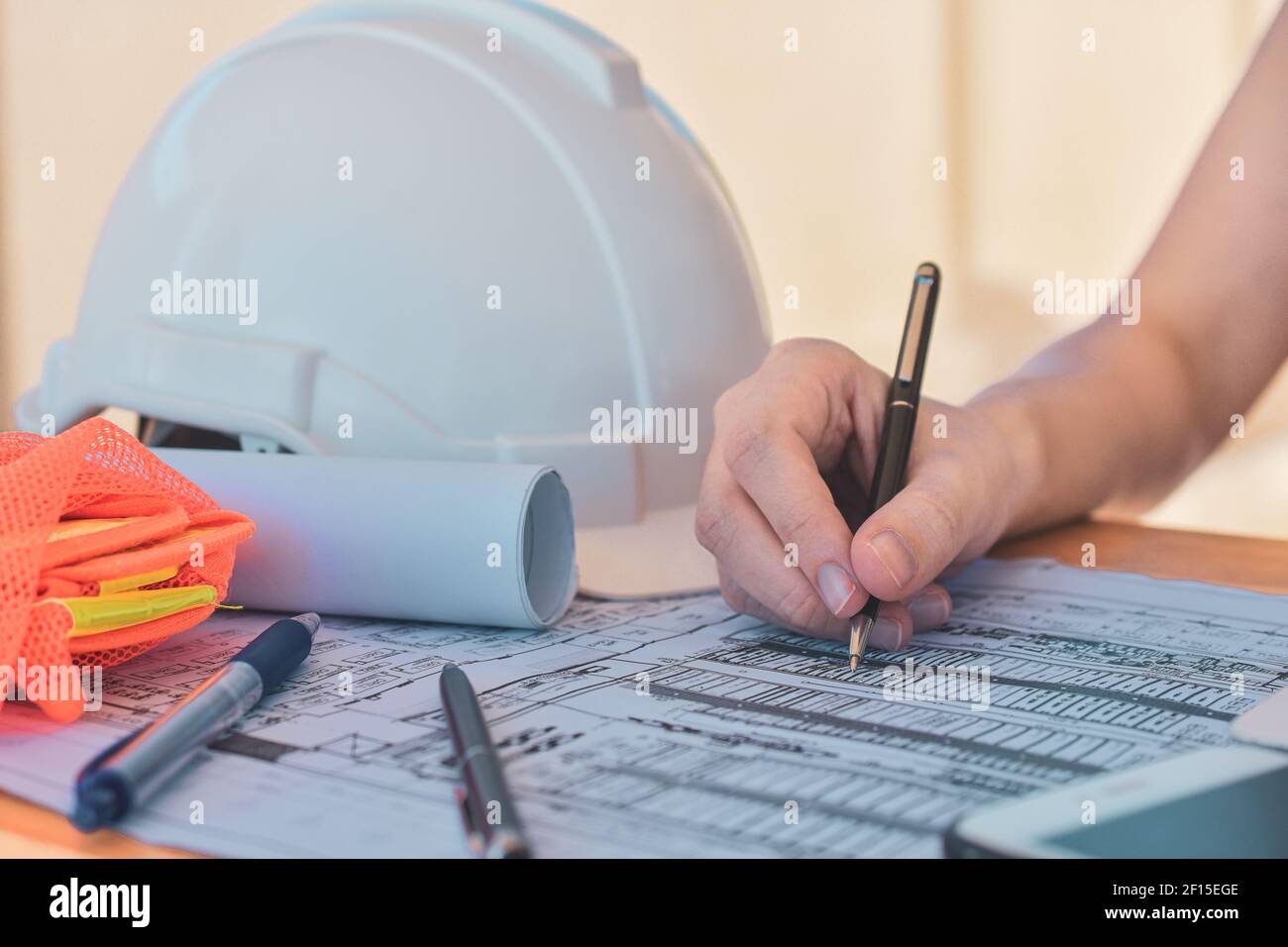 Close up hand check design on blueprint for building construction ...