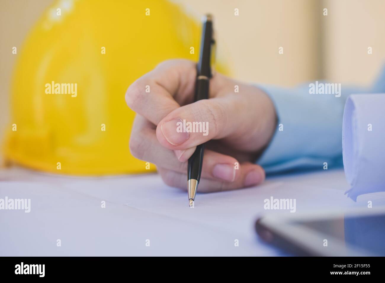 Close up hand check design on blueprint for building construction ...