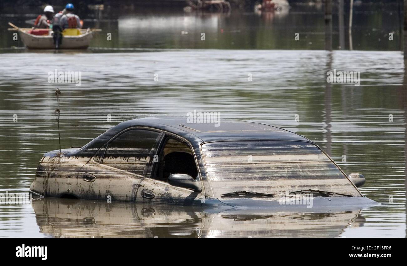A car serves as an indicator of how much flood waters have receded in ...