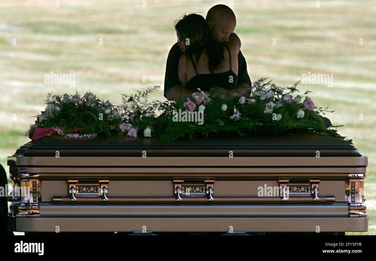 Sarah Crislip is comforted by her boyfriend, Scott Sander, after a ...