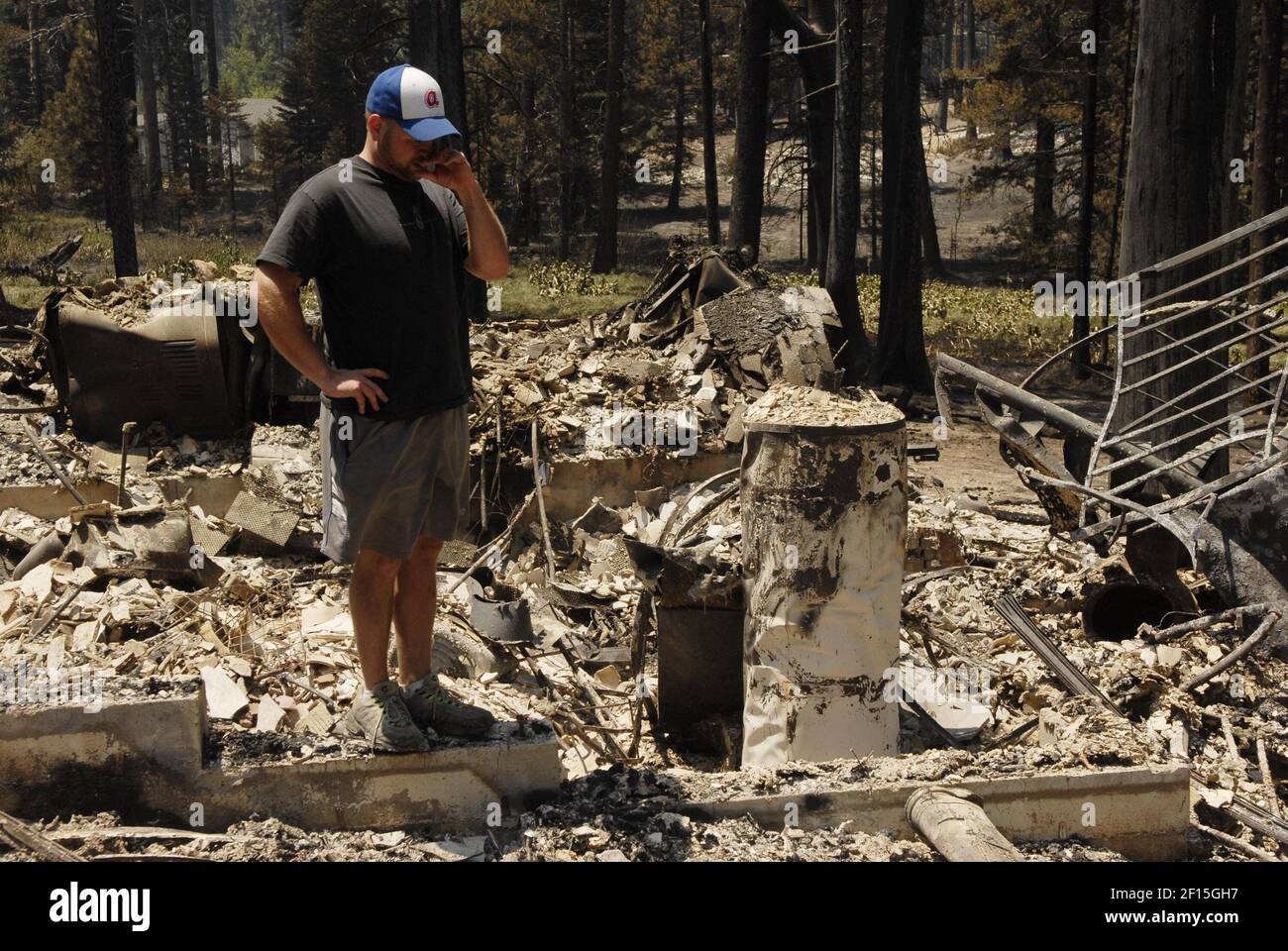 David Risser, 26, looks for remains of his dog, Rocky, outside his ...
