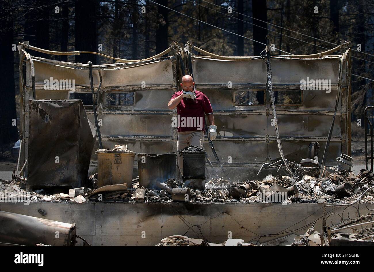 Rob Beaty sifts through the remains of his mother's home in South Lake ...