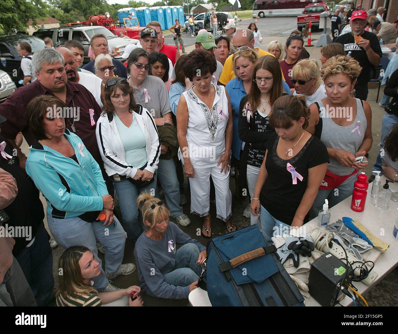 A somber group of volunteers watch a news Greentown Fire Department in ...