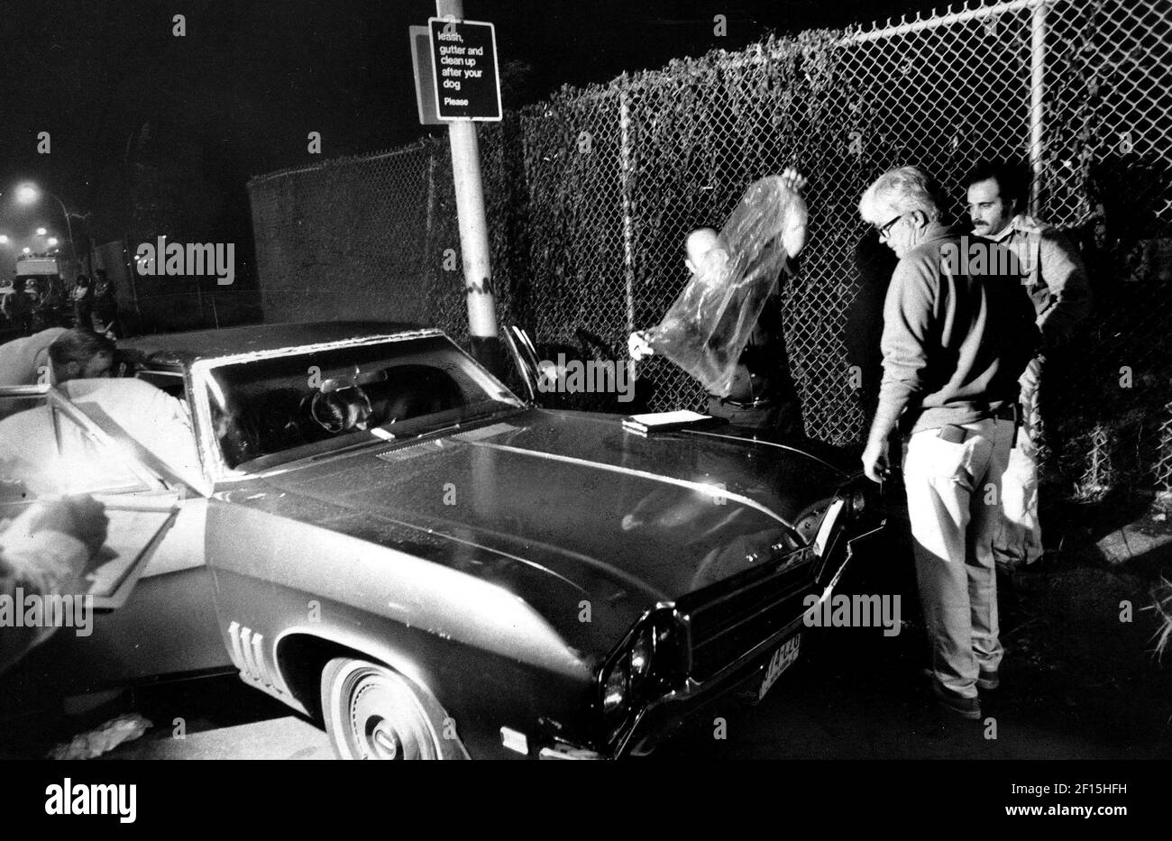 A police officer leans over in front seat of Robert Violante's car on ...